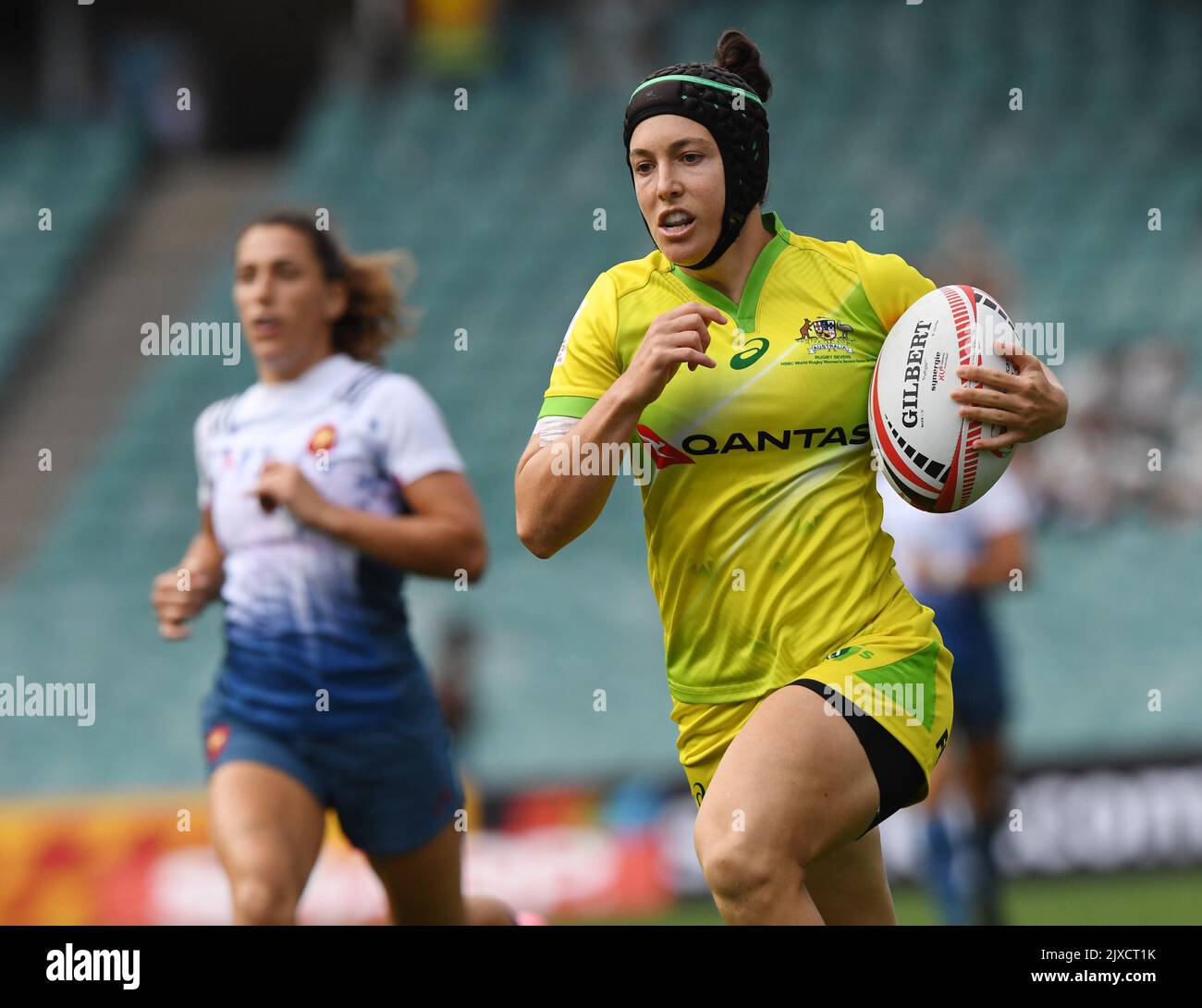 Emilee Cherry of Australia runs with the ball before scoring a try ...