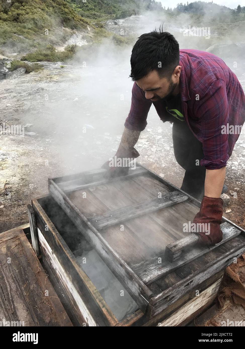 A Hangi pit is used to cook lunch at Te Puia Geothermal Park in Rotorua ...