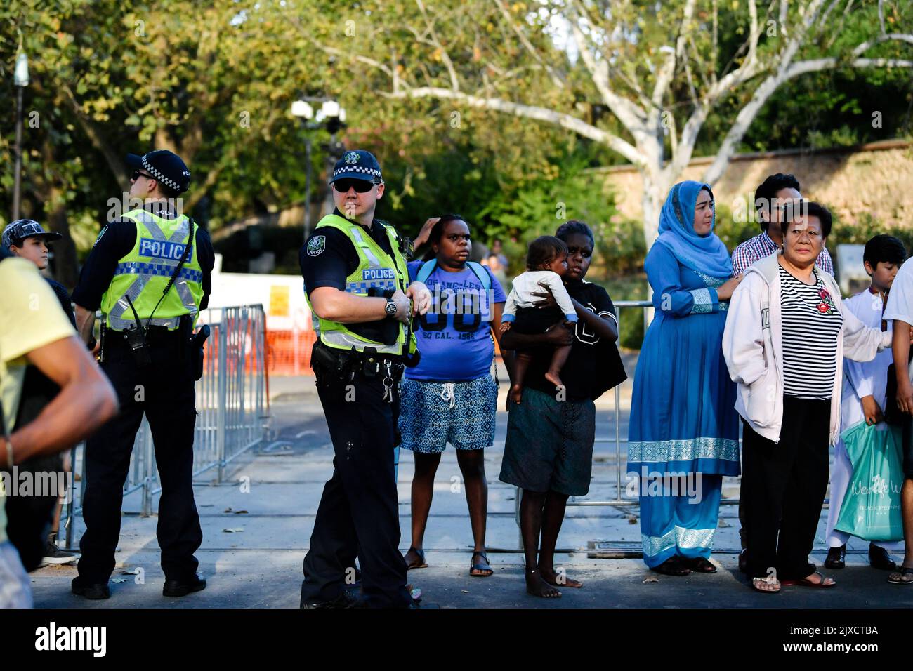 Police are seen watching spectators at the Australia Day Parade down ...