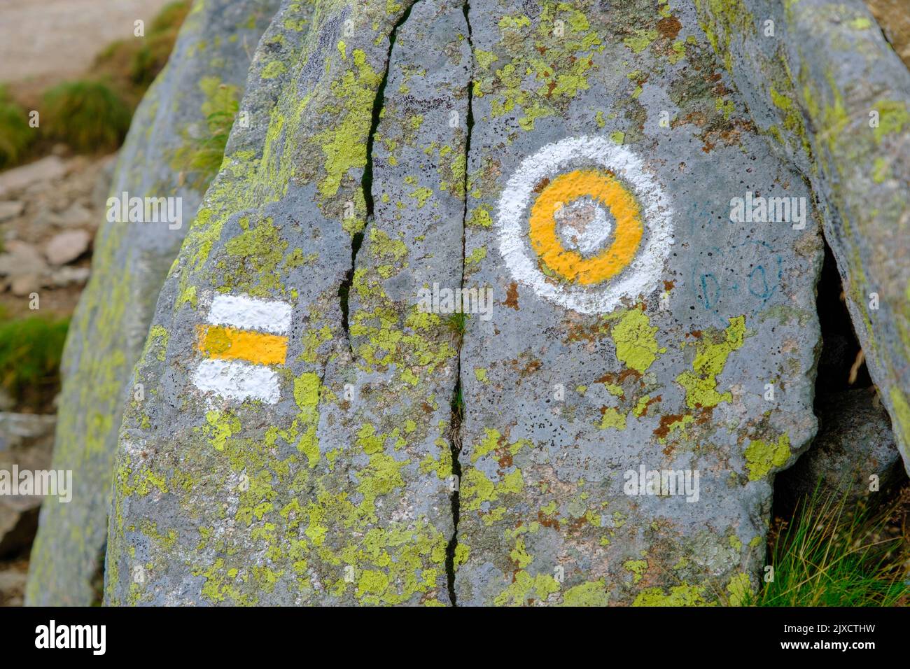 Yellow difficulty tourist hike sign on the top of the mountain on a ...