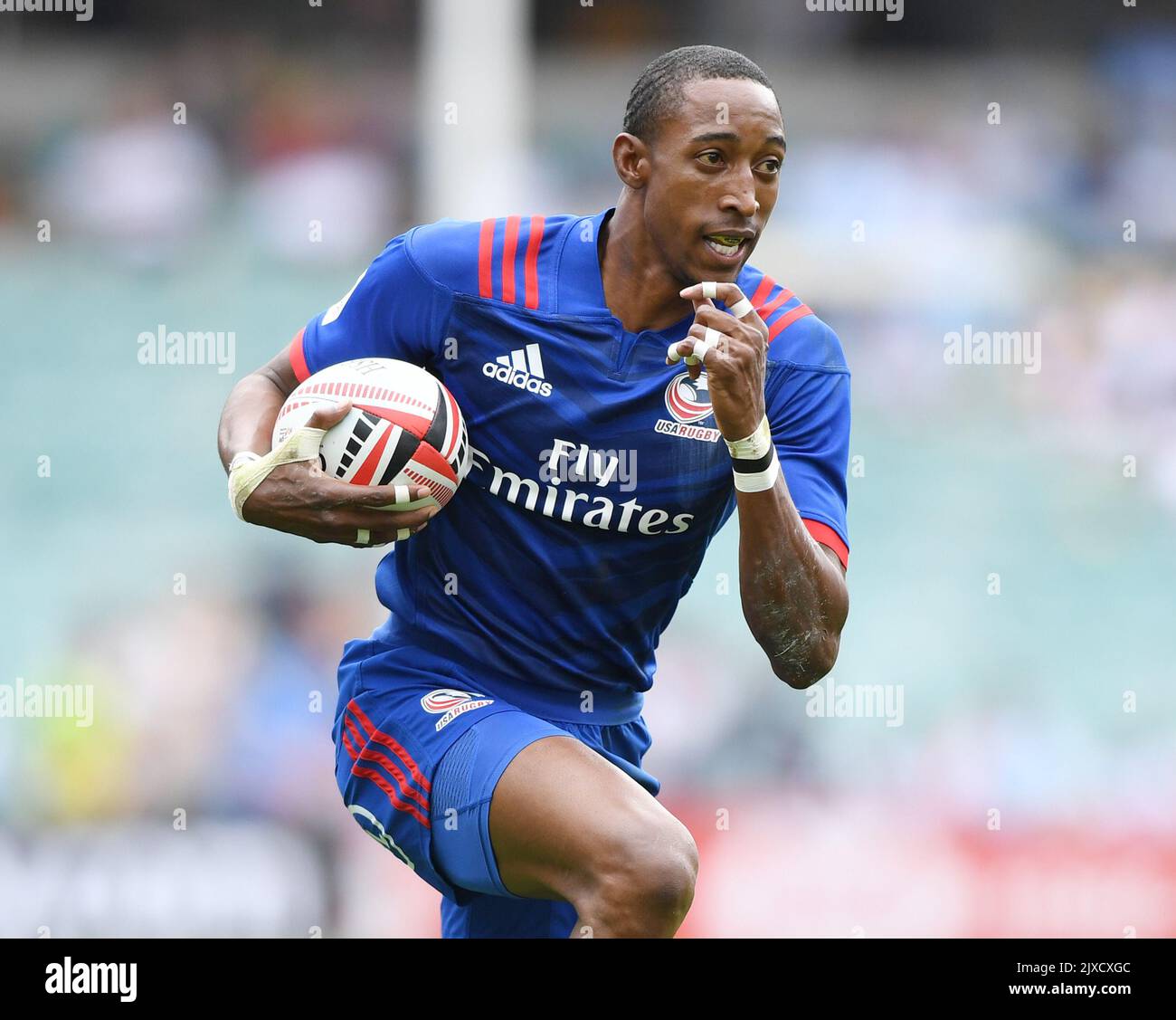 Perry Baker of the US runs with the ball before scoring a try against ...