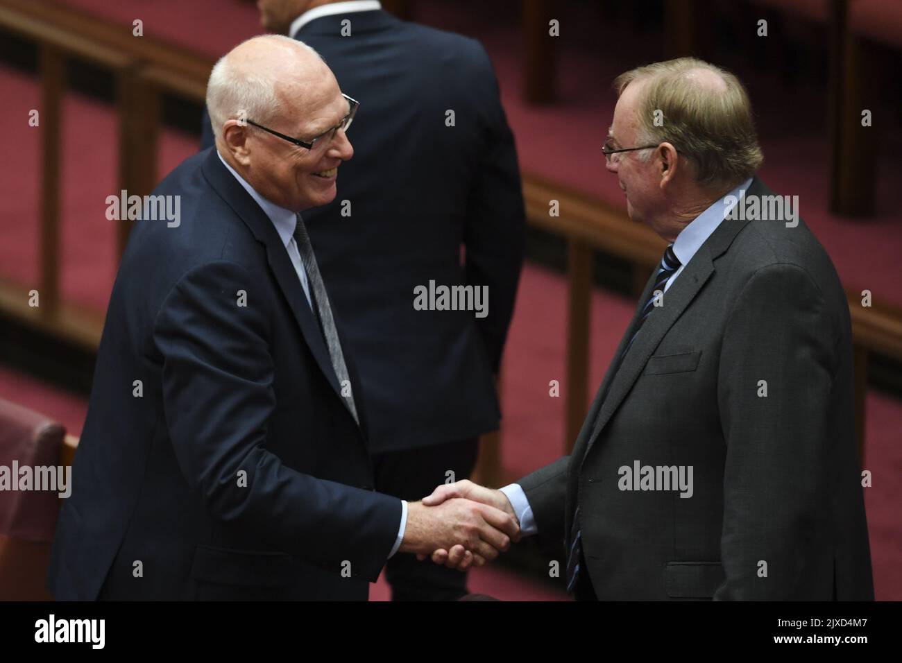 Liberal Senator Ian Macdonald (right) congratulates Liberal Senator Jim ...