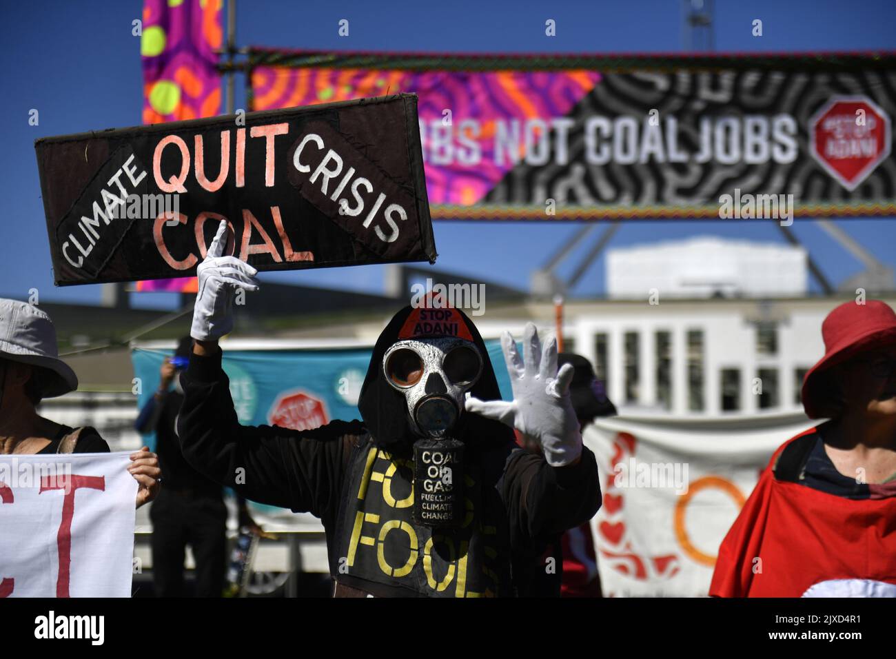 Protesters hold signs and banners at a Stop Adani Mine rally on the ...