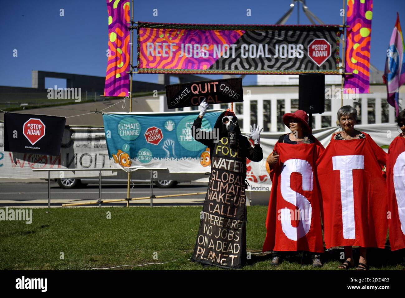 Protesters hold signs and banners at a Stop Adani Mine rally on the ...