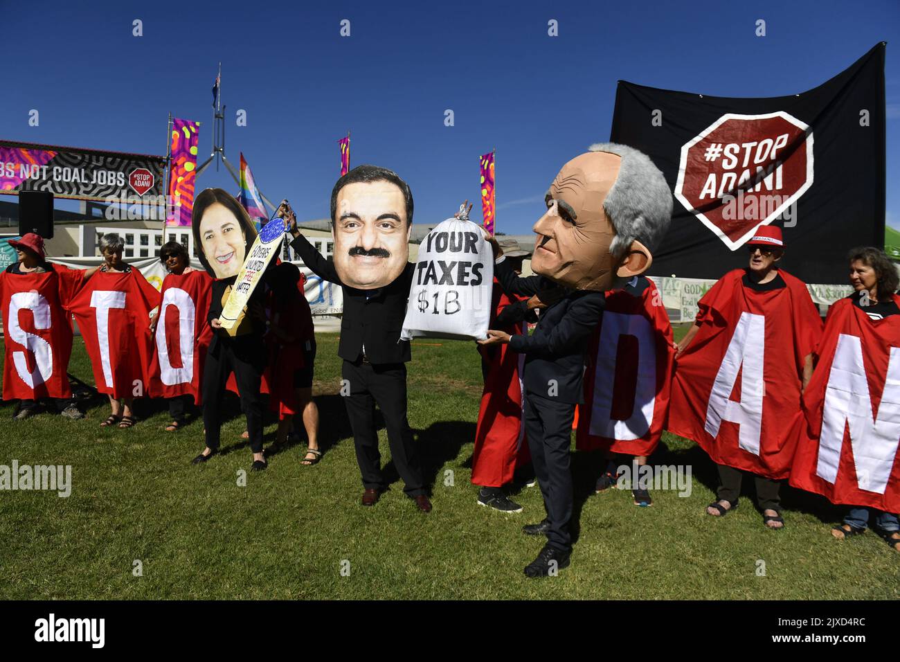 Protesters hold signs and banners at a Stop Adani Mine rally on the ...