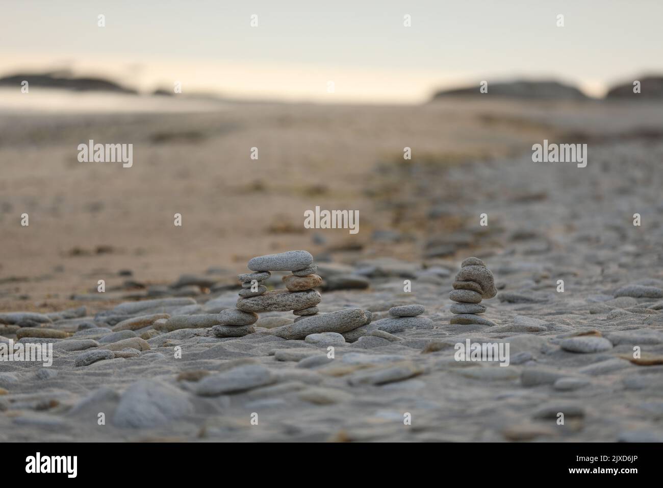 Stone male stones yoga meditation on the beach Stock Photo - Alamy