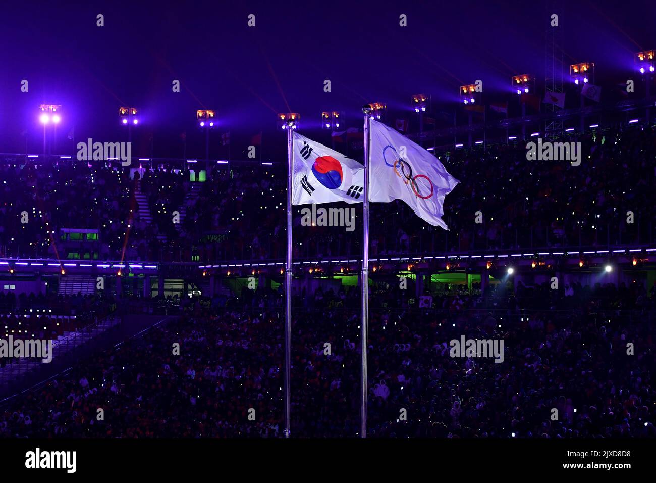 The Korean and Olympic flags are seen flying during the Opening ...