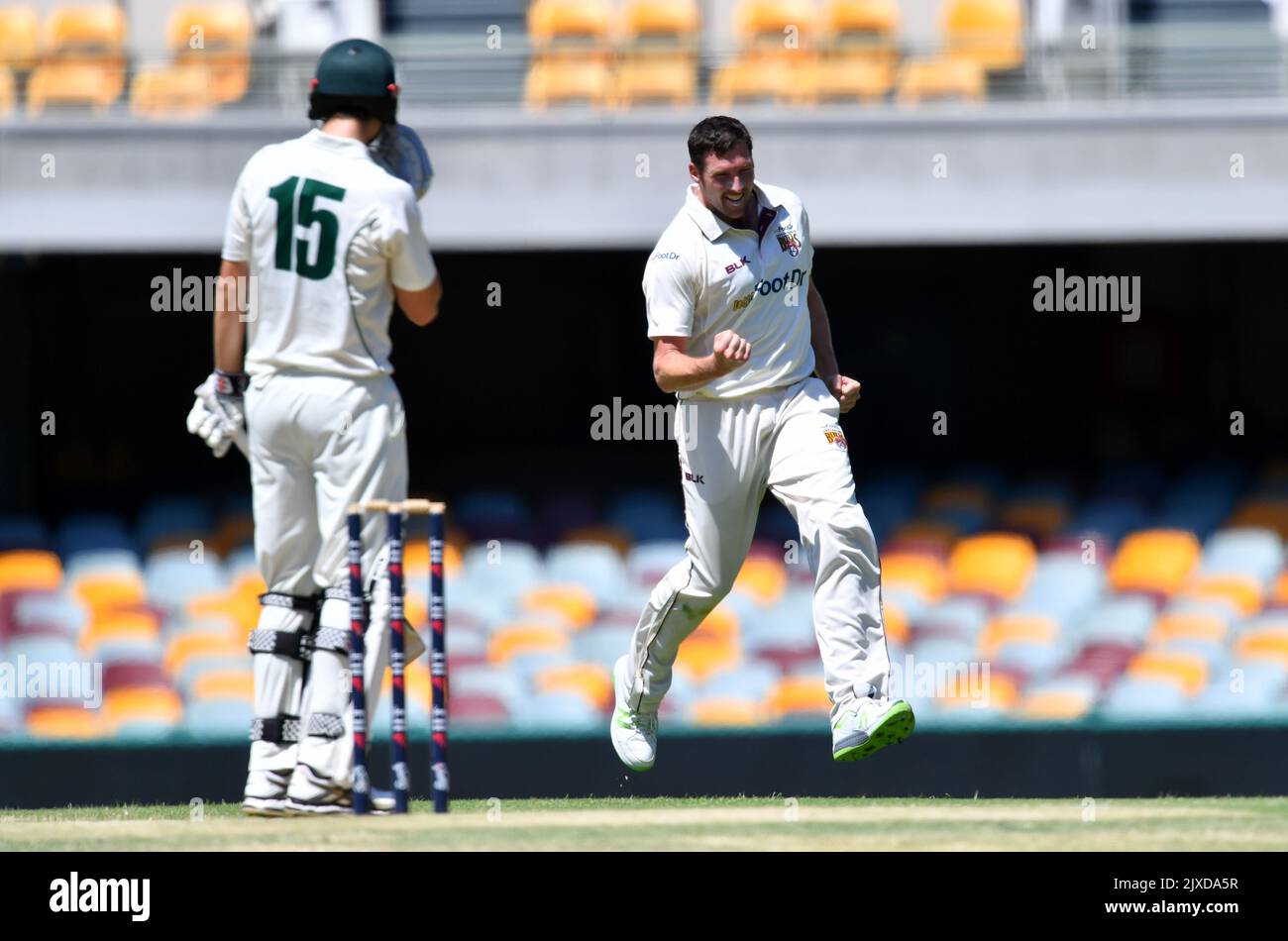 Luke Feldman (right) of Queensland celebrates the wicket of Simon ...