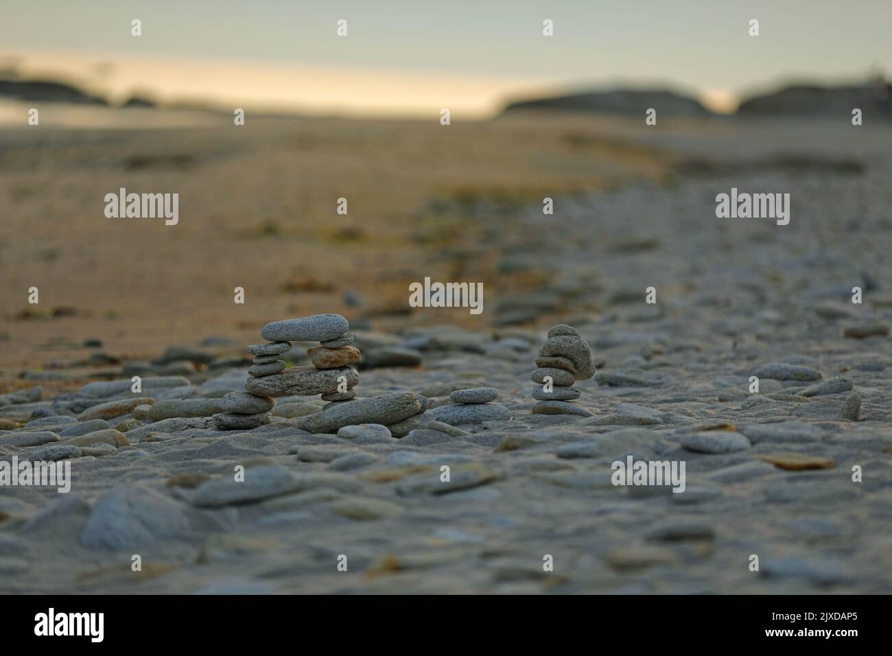 Stone male stones yoga meditation on the beach Stock Photo - Alamy