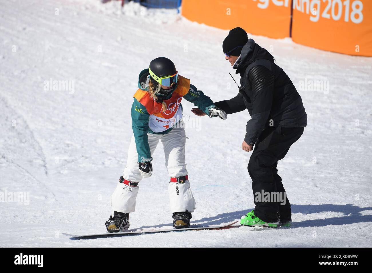 Emily Arthur of Australia is helped by an official after falling during ...