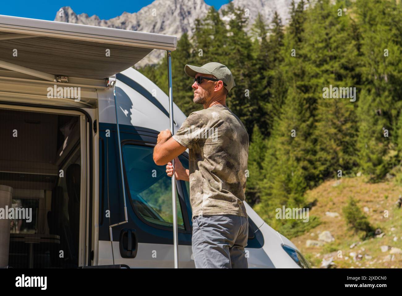 Caucasian Middle Aged Man Securing His RV Sunshade with Awning Rods ...