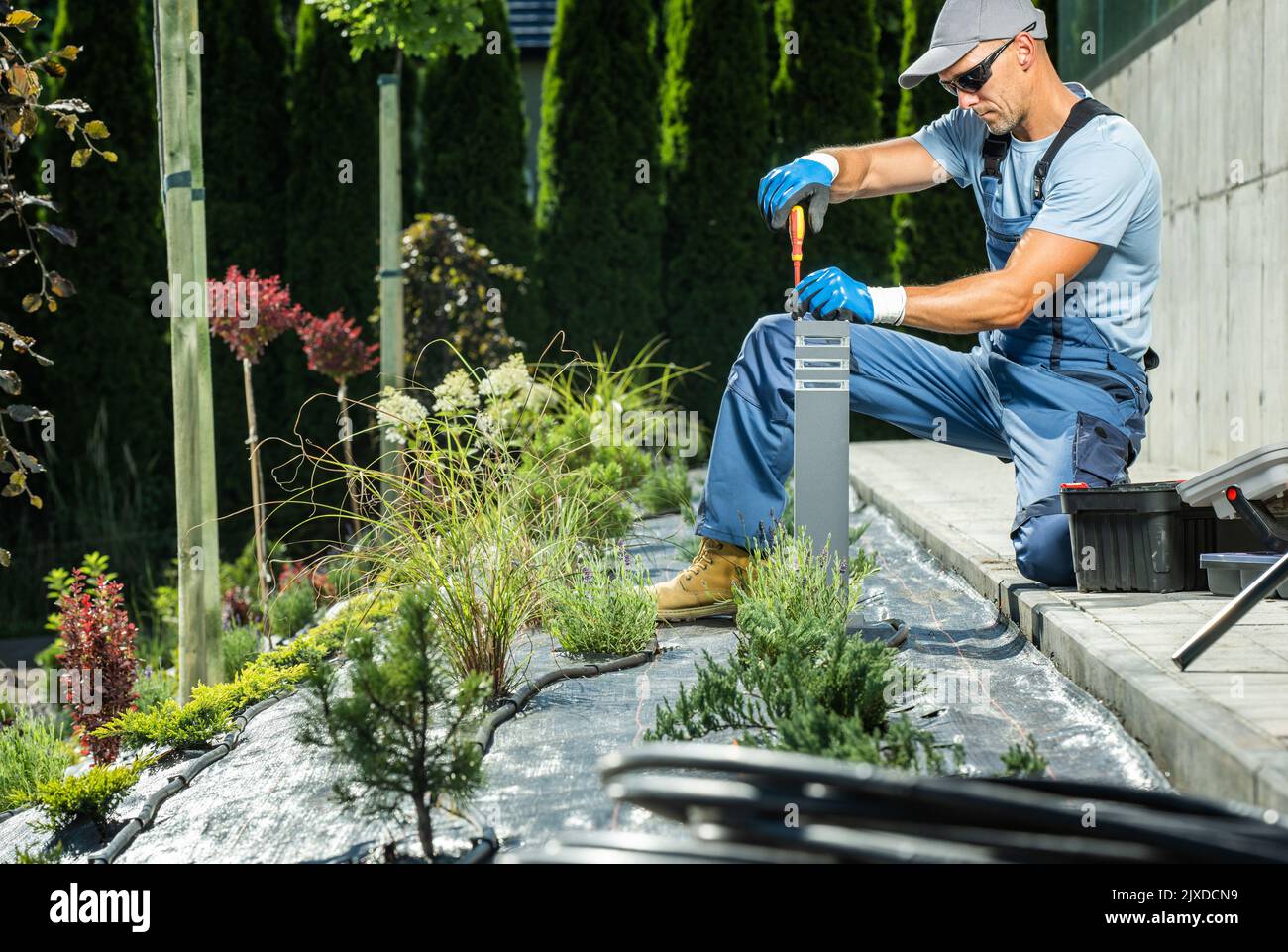 Caucasian Male Landscape Electrician with Opened Toolbox Next to Him ...