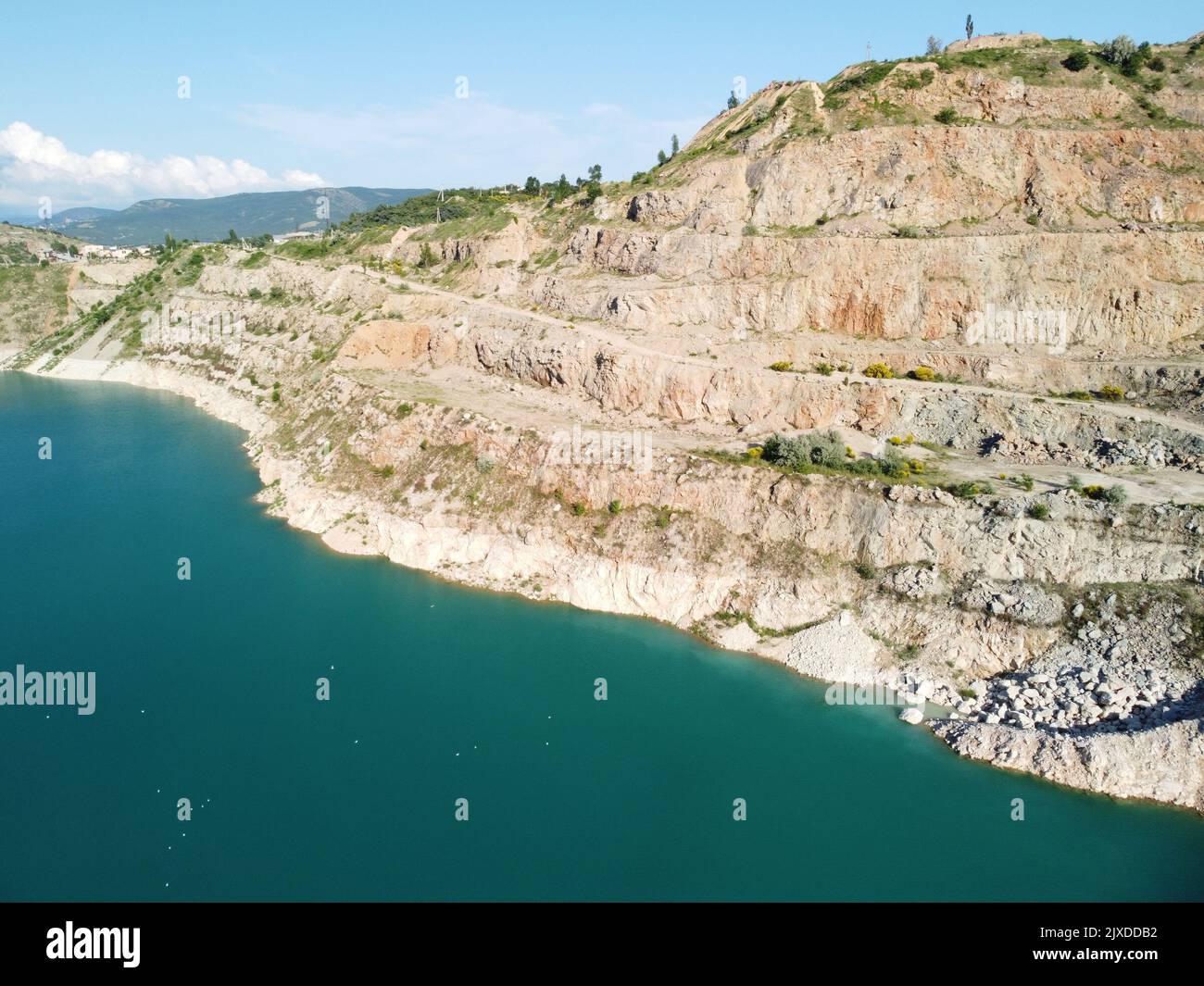 Aerial top view on opencast mining quarry with flooded bottom ...