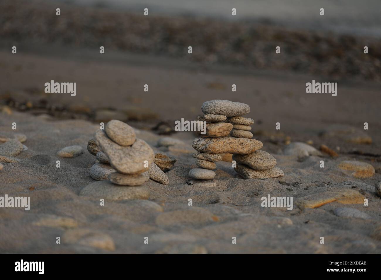 Stone male stones yoga meditation on the beach Stock Photo - Alamy