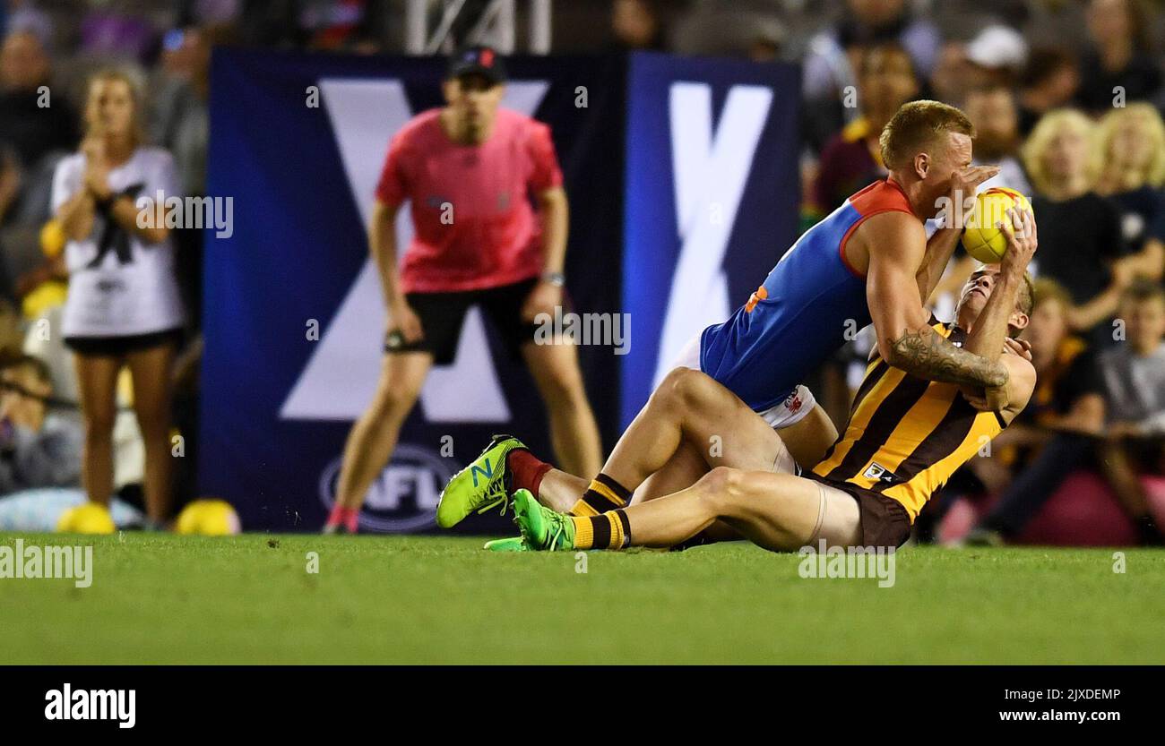 James Harmes of the Demons tackles Oliver Hanrahan of the Hawks during ...