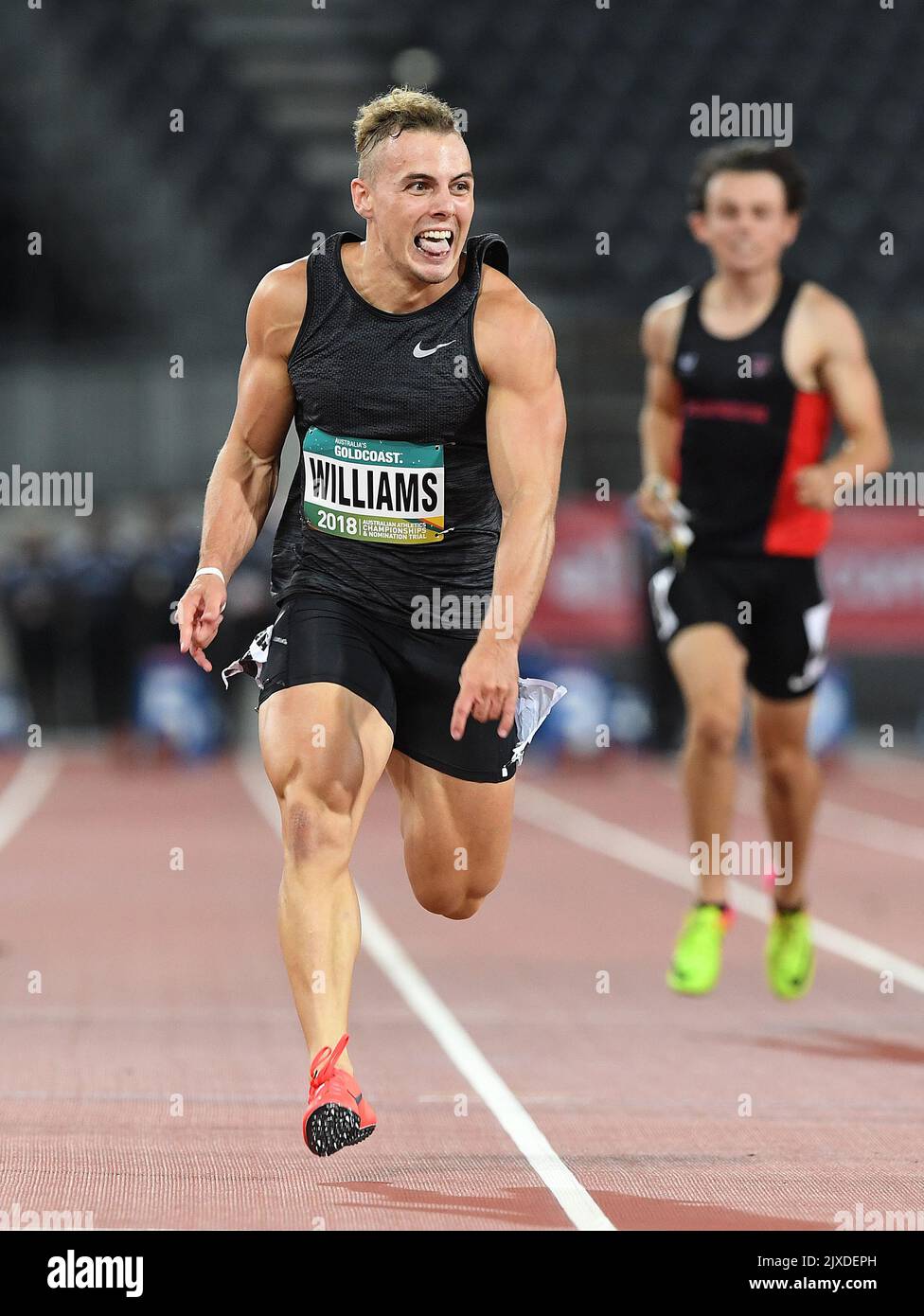 Trae Williams of Queensland crosses the line to win the Mens 100m Final ...