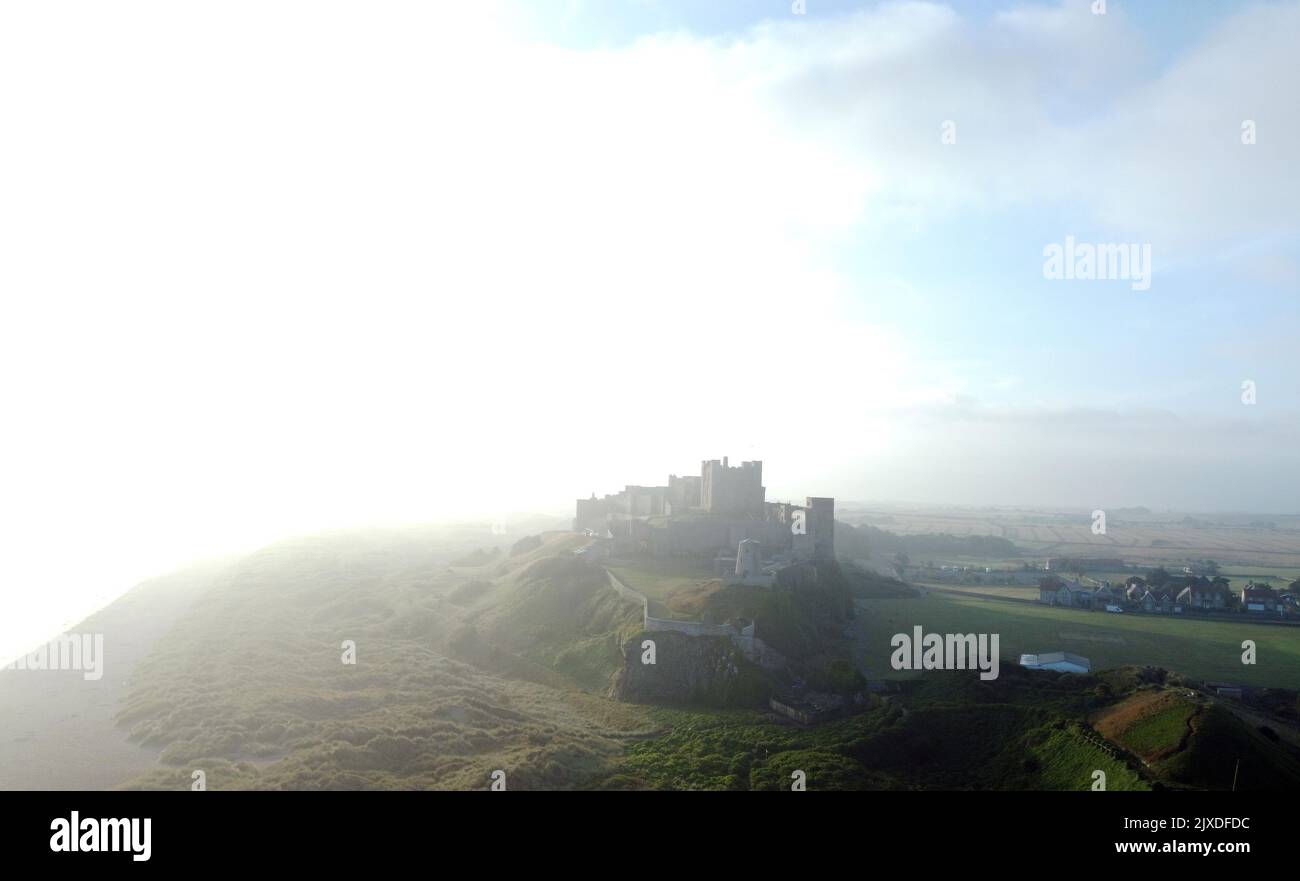 Bamburgh Castle in Northumberland in the early morning mist. Picture ...