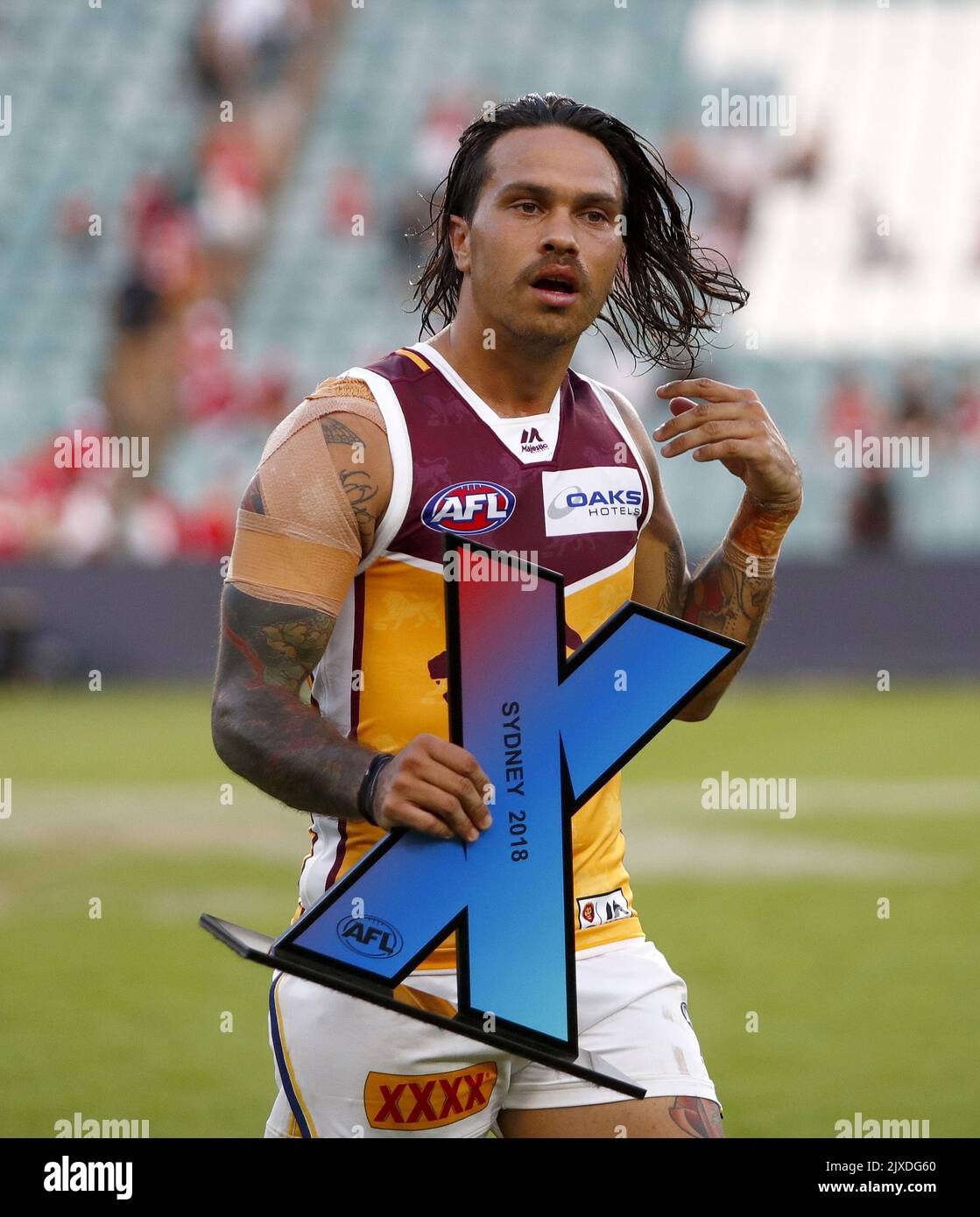 Allen Christensen of the Lions walks with the trophy after winning the ...