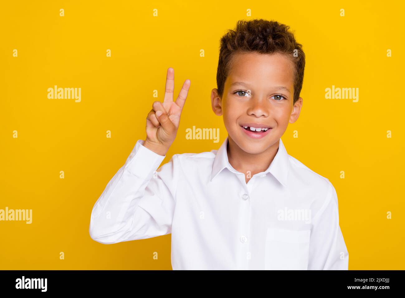 Photo of cute boy stylish white clothes arm demonstrate hi symbol give ...
