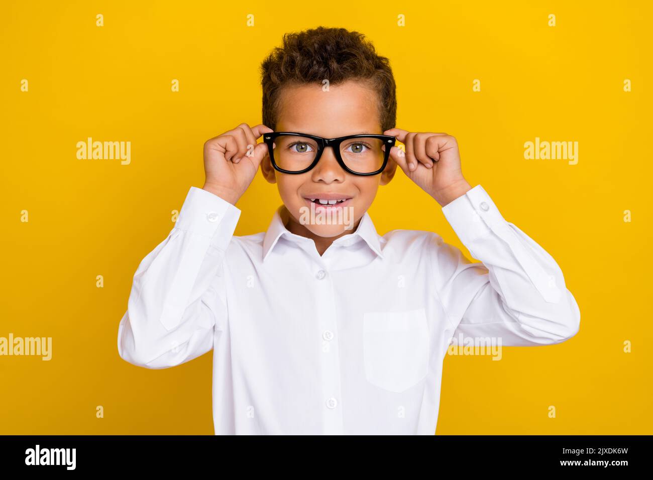 Photo of clever cute schoolkid boy arm touch enjoiy new eye accessory ...
