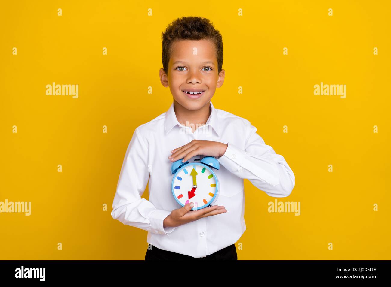 Portrait of positive person hands hold classic bell clock toothy smile ...