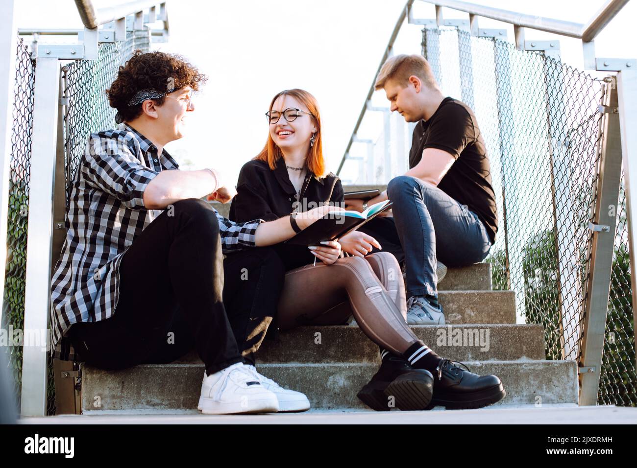 Two people sitting on stairs hi-res stock photography and images - Alamy
