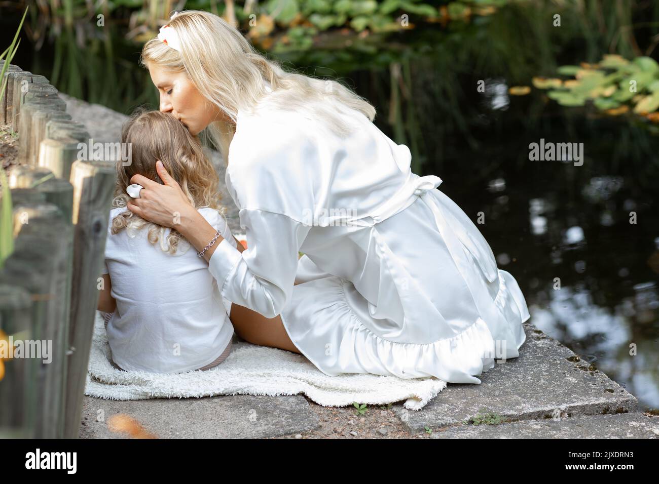 Girl kissing woman back view hi-res stock photography and images - Alamy