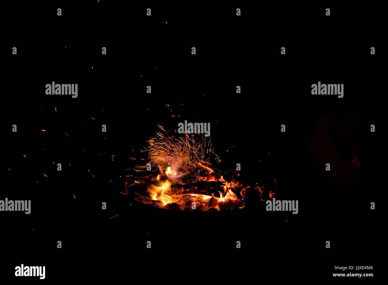 Campfire flame sparks isolated on black background. Fire flames heat ...