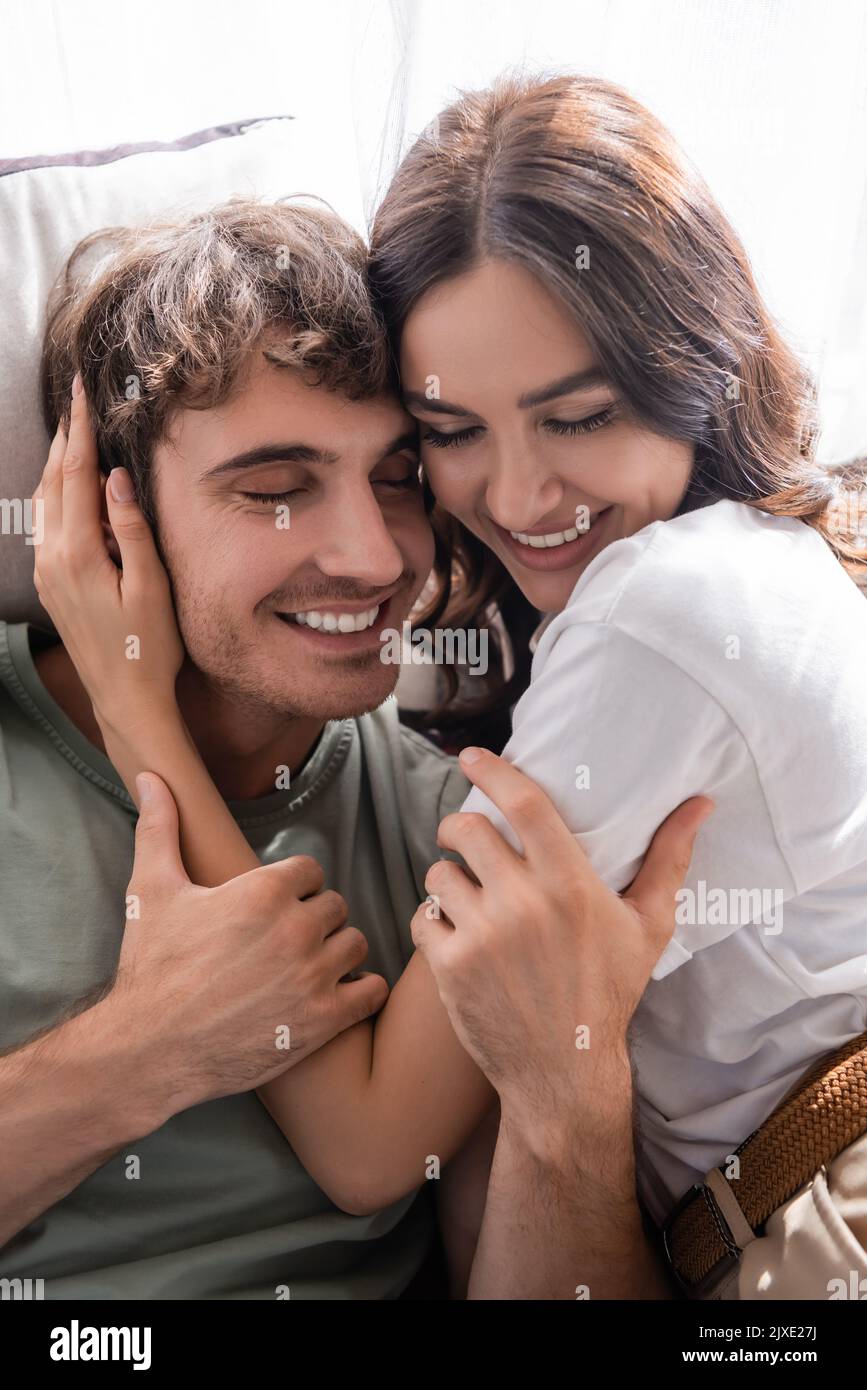 Happy young woman hugging boyfriend in camper van,stock image Stock Photo - Alamy