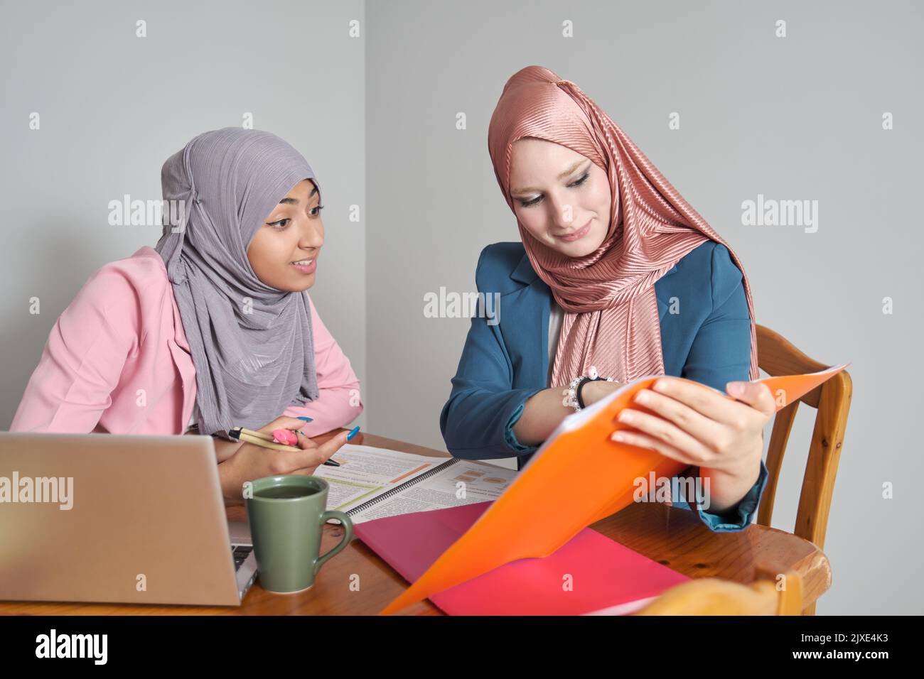 Two muslim female university students wearing hijab studying after ...