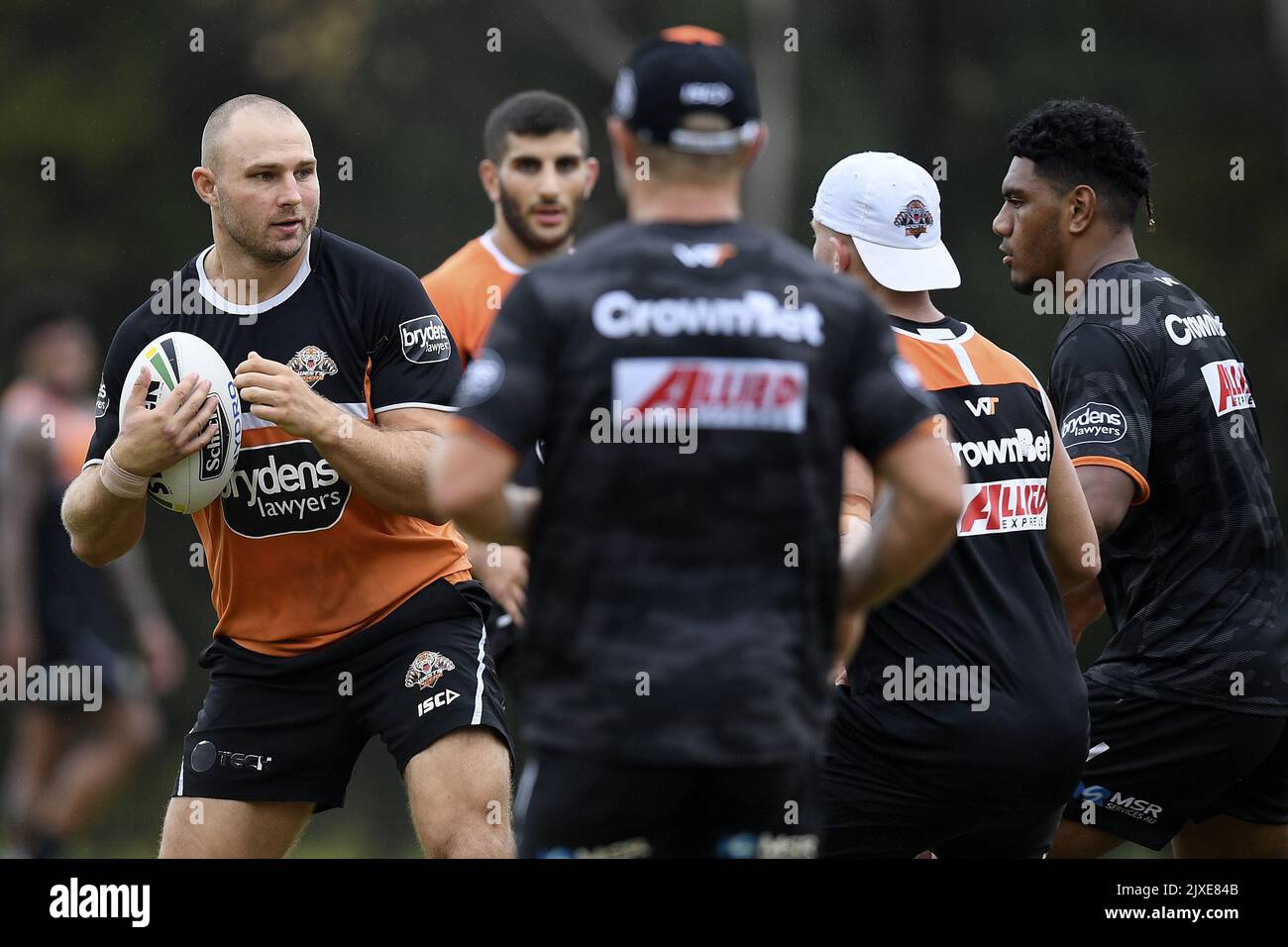 Wests Tigers player Robbie Rochow (left) takes part in a training ...