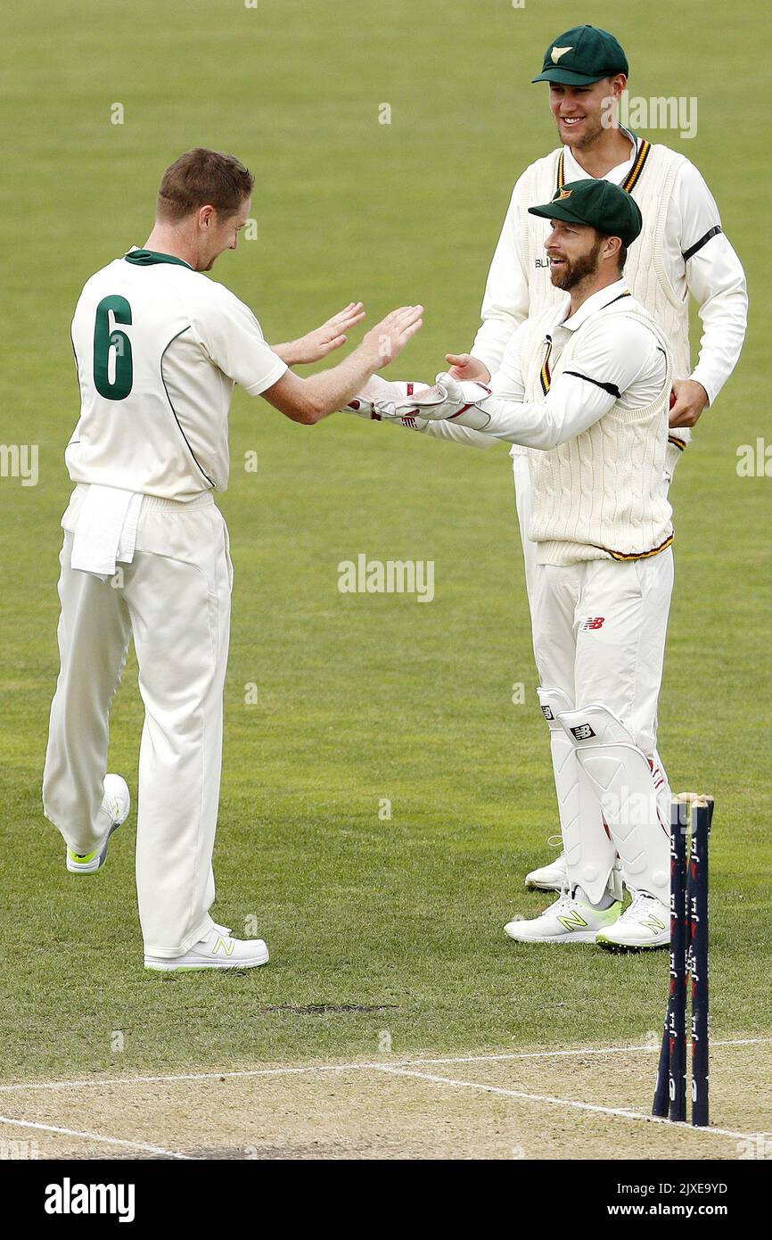 Tom Rogers of Tasmania (left) celebrates after bowling Daniel Christian ...