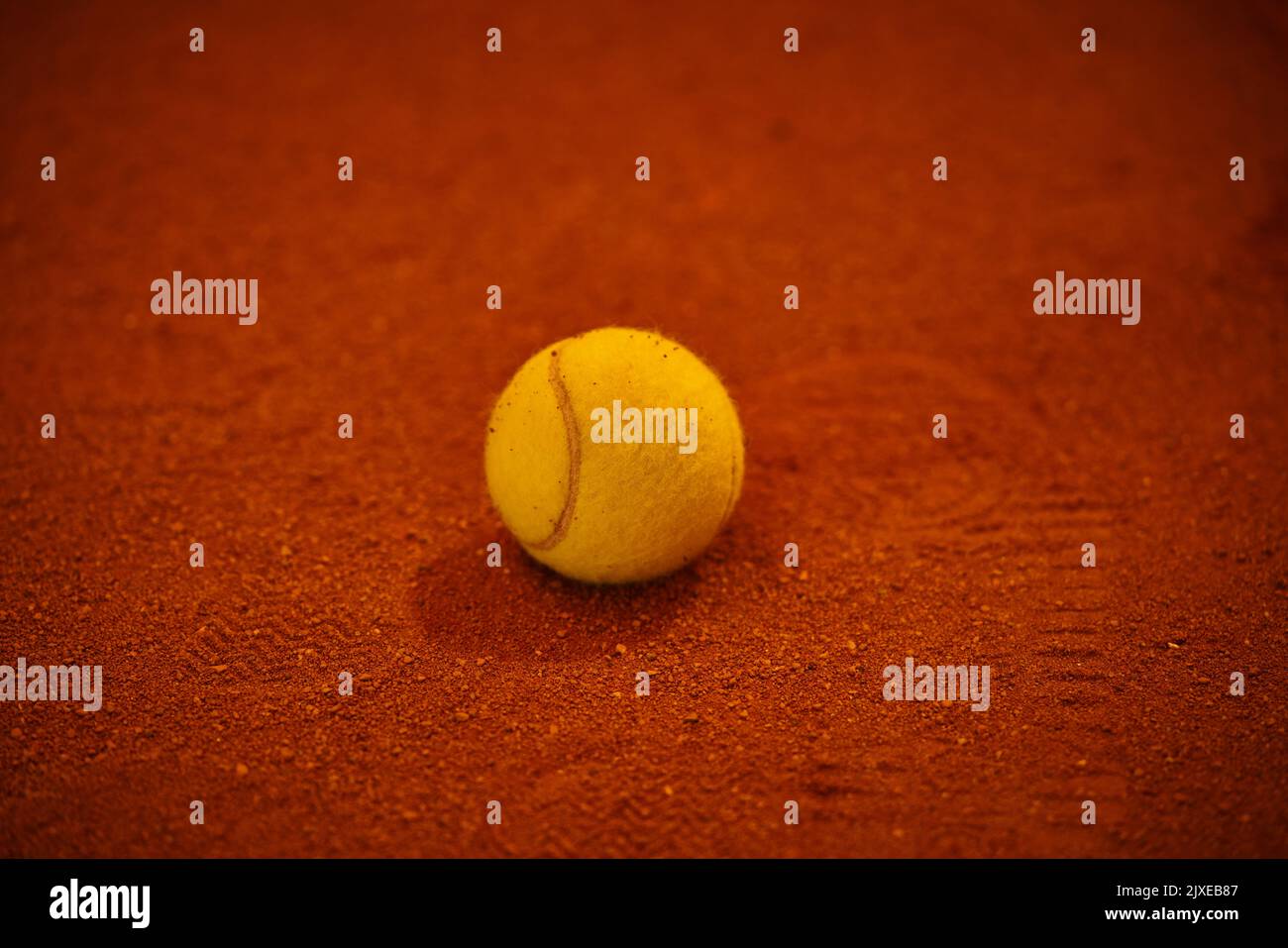Yellow tennis ball lying on line of the red and green court. Flat lay ...