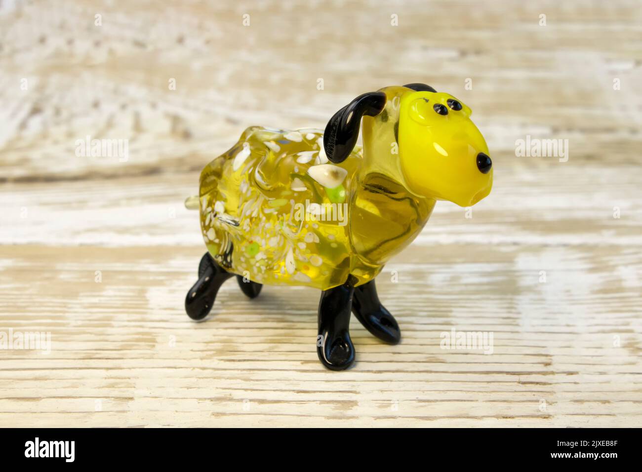 Glass Sheep Animal Figurines Miniature on rough wooden background front ...