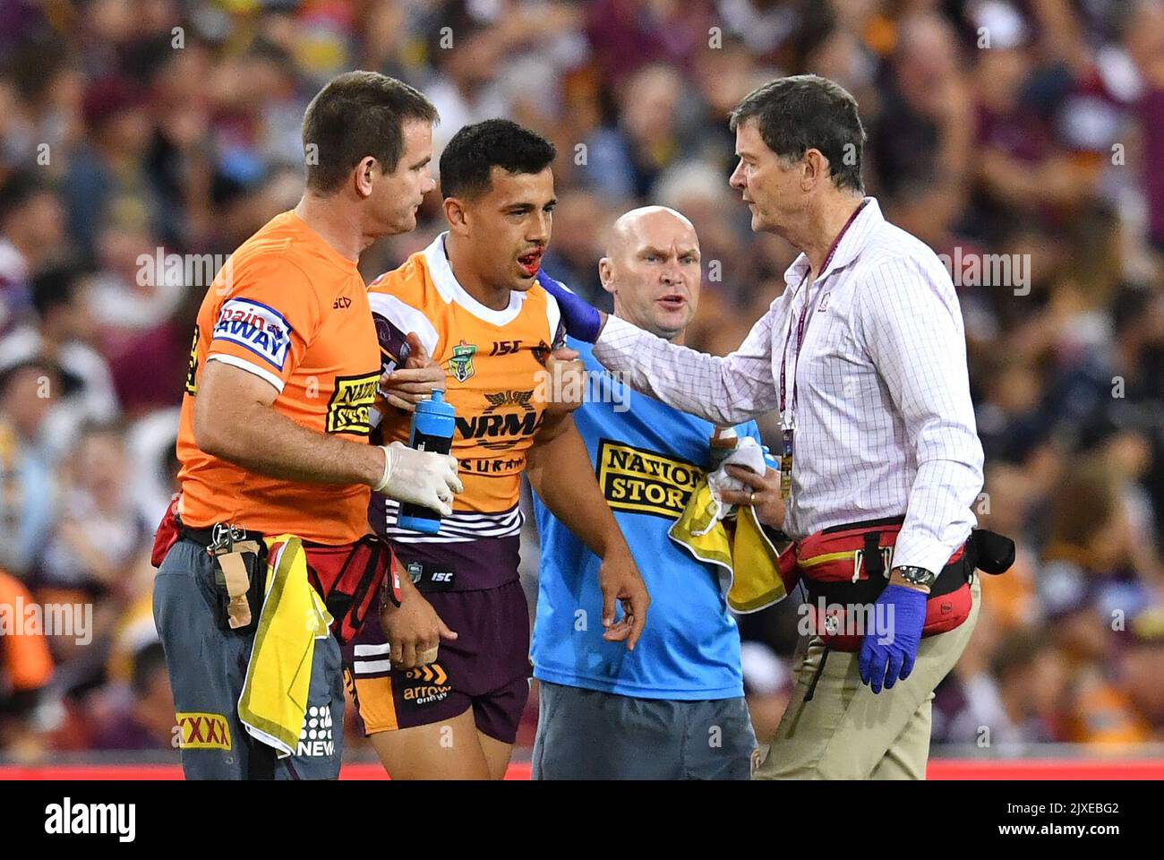 Jordan Kahu (2nd from left) of the Broncos is seen getting help from ...