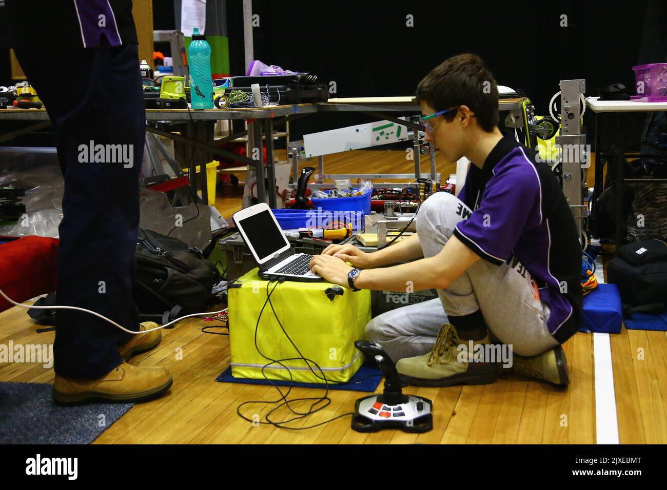 A competitor codes on his laptop during the FIRST Australia Robotics ...