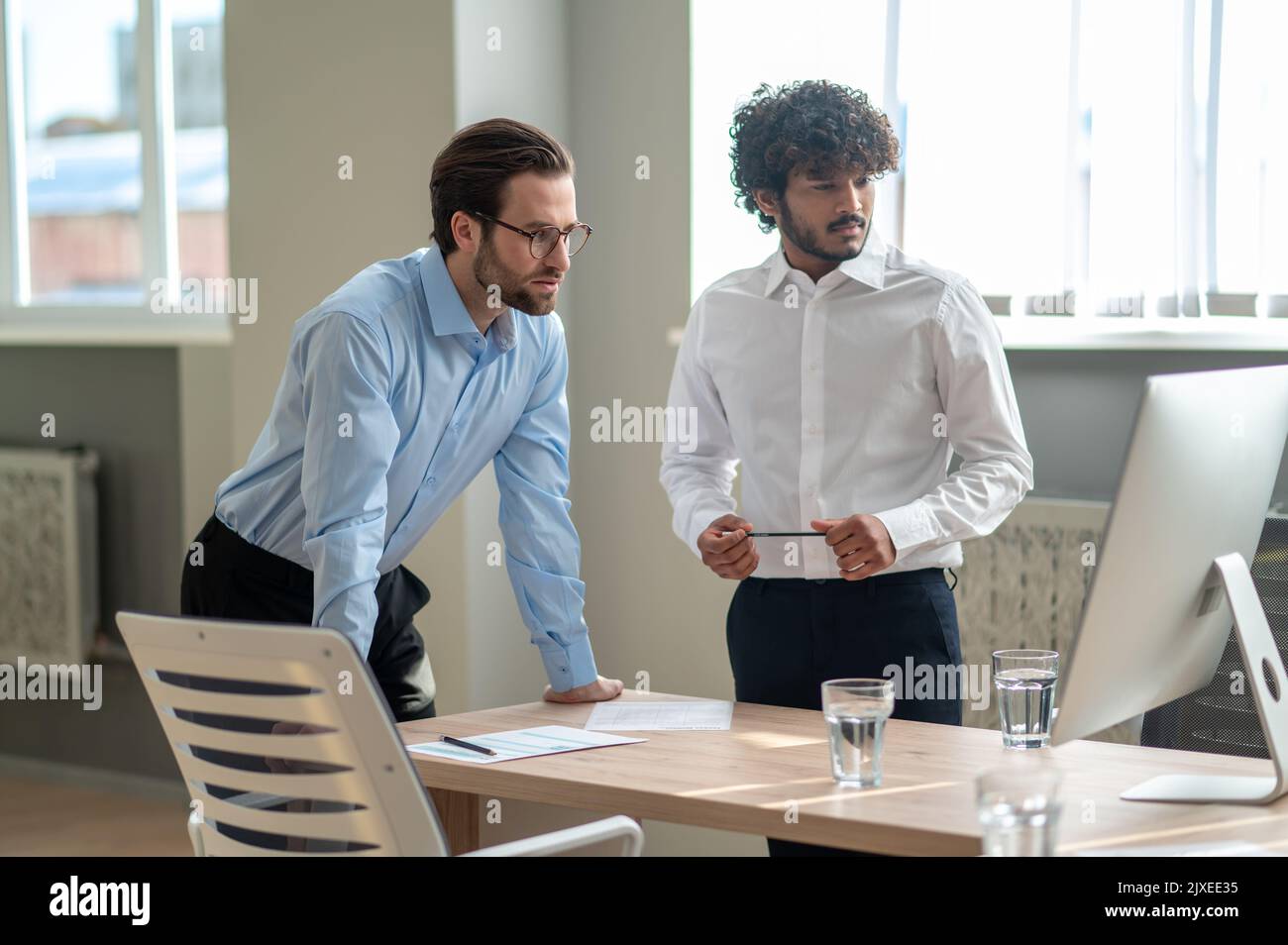 Work on project. Two businessmen looking busy while discussing project ...