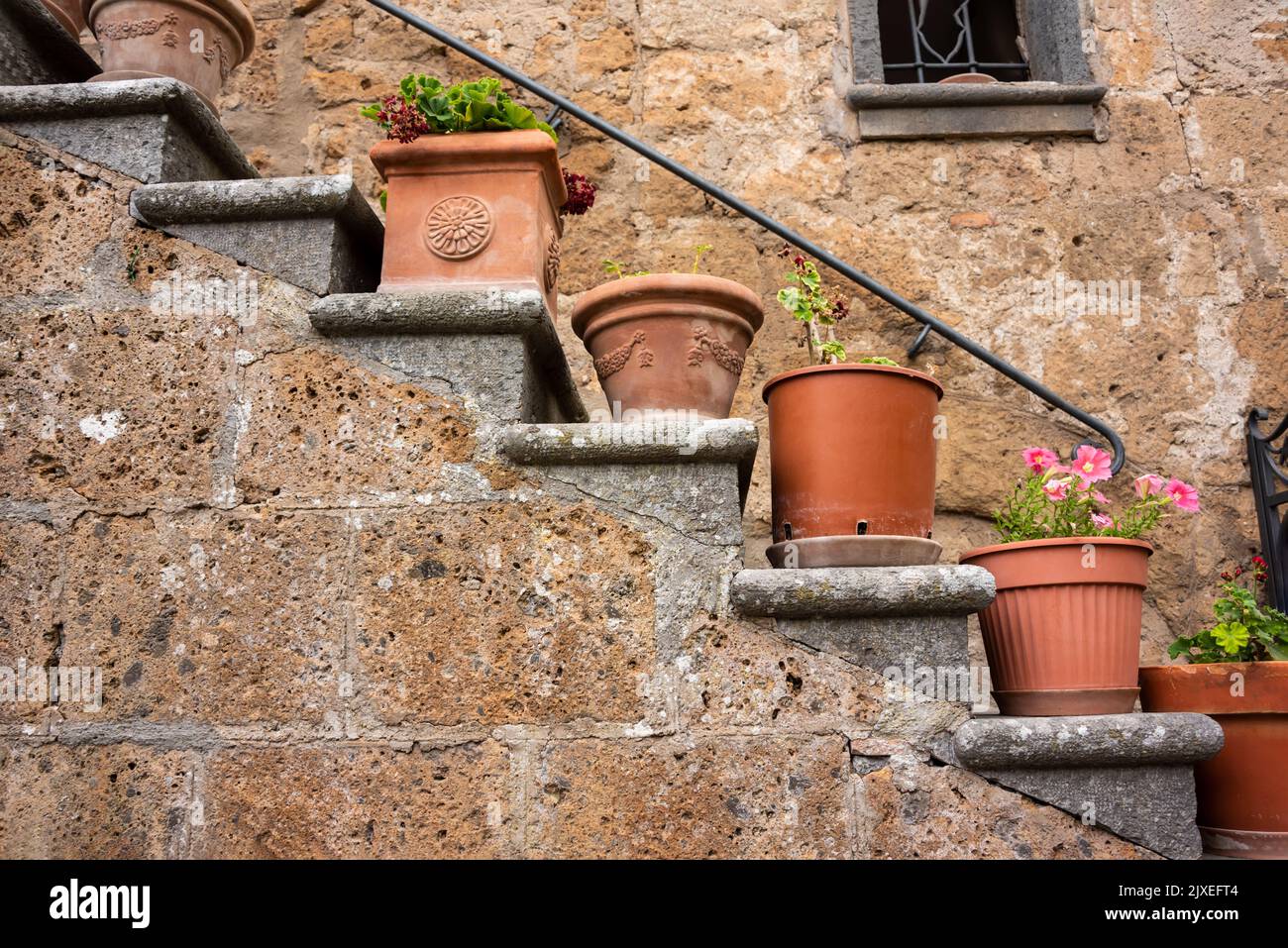 Picturesque stone staircase with plant pots in medieval town in Tuscany ...