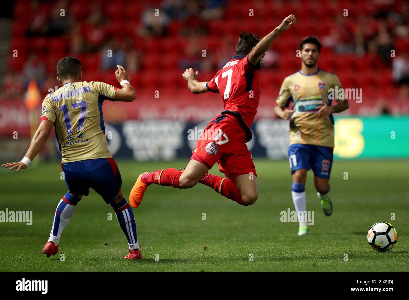 Daniel Georgievski of the Newcastle Jets tackles Nikola Mileusnic of ...