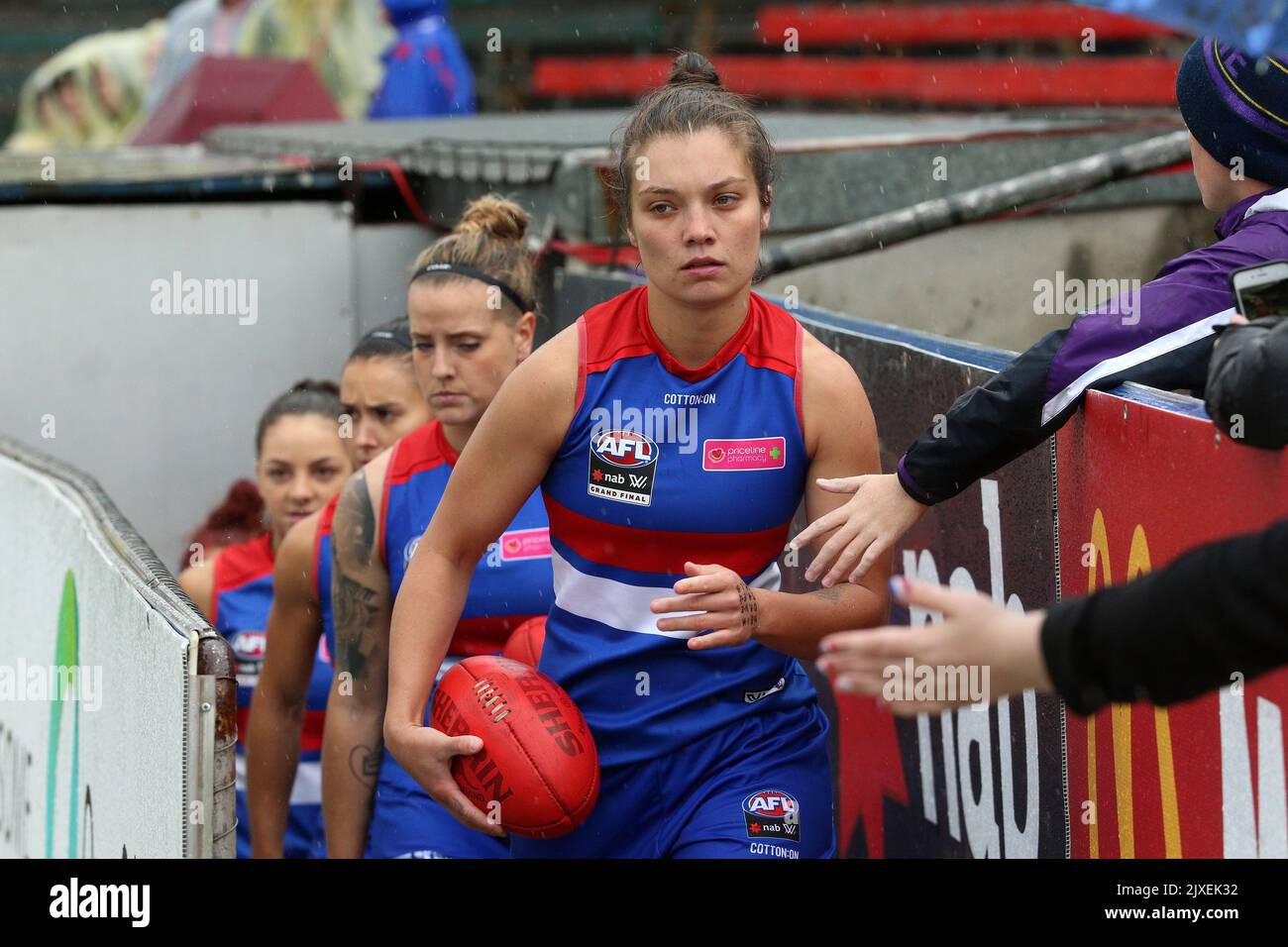 Ellie Blackburn of the Bulldogs leads her team out ahead of the AFLW ...