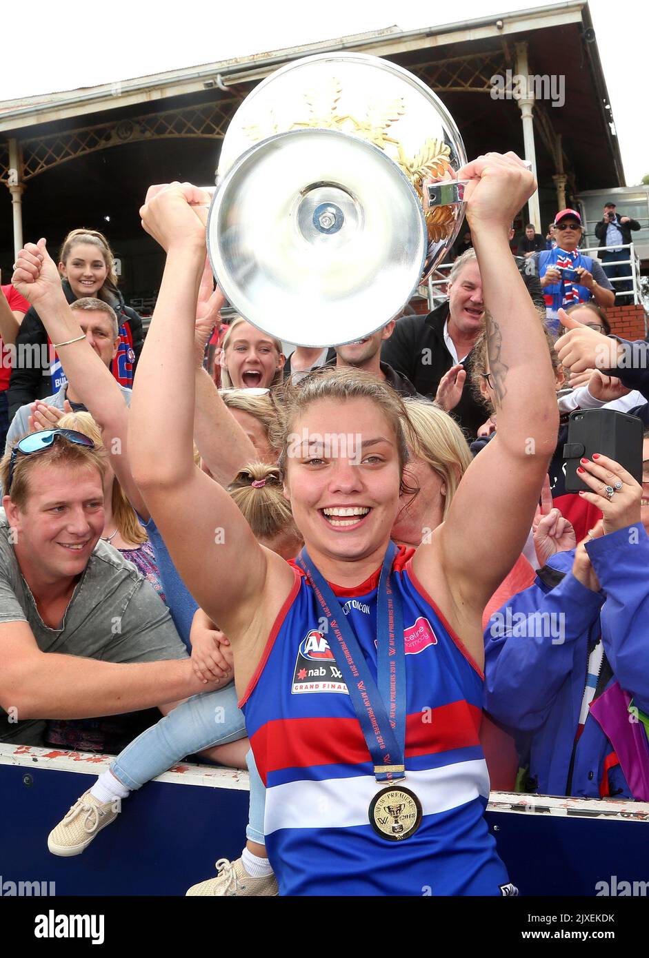 Ellie Blackburn of the Bulldogs celebrates with the trophy after the ...