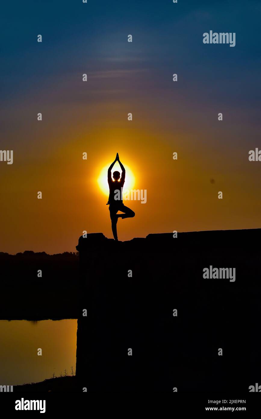 A person doing yoga and exercise in the morning on the front of rising ...