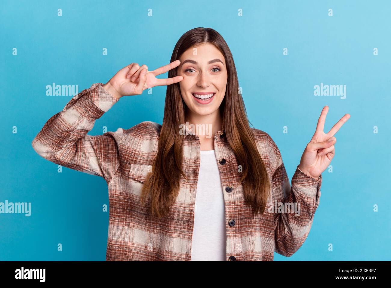 Photo of charming glad young girl two hands fingers demonstrate v-sign ...