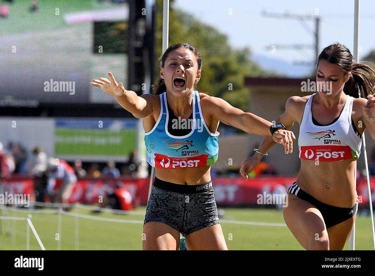 Sprinter Elizabeth Forsyth (centre) from Queensland crosses the finish ...