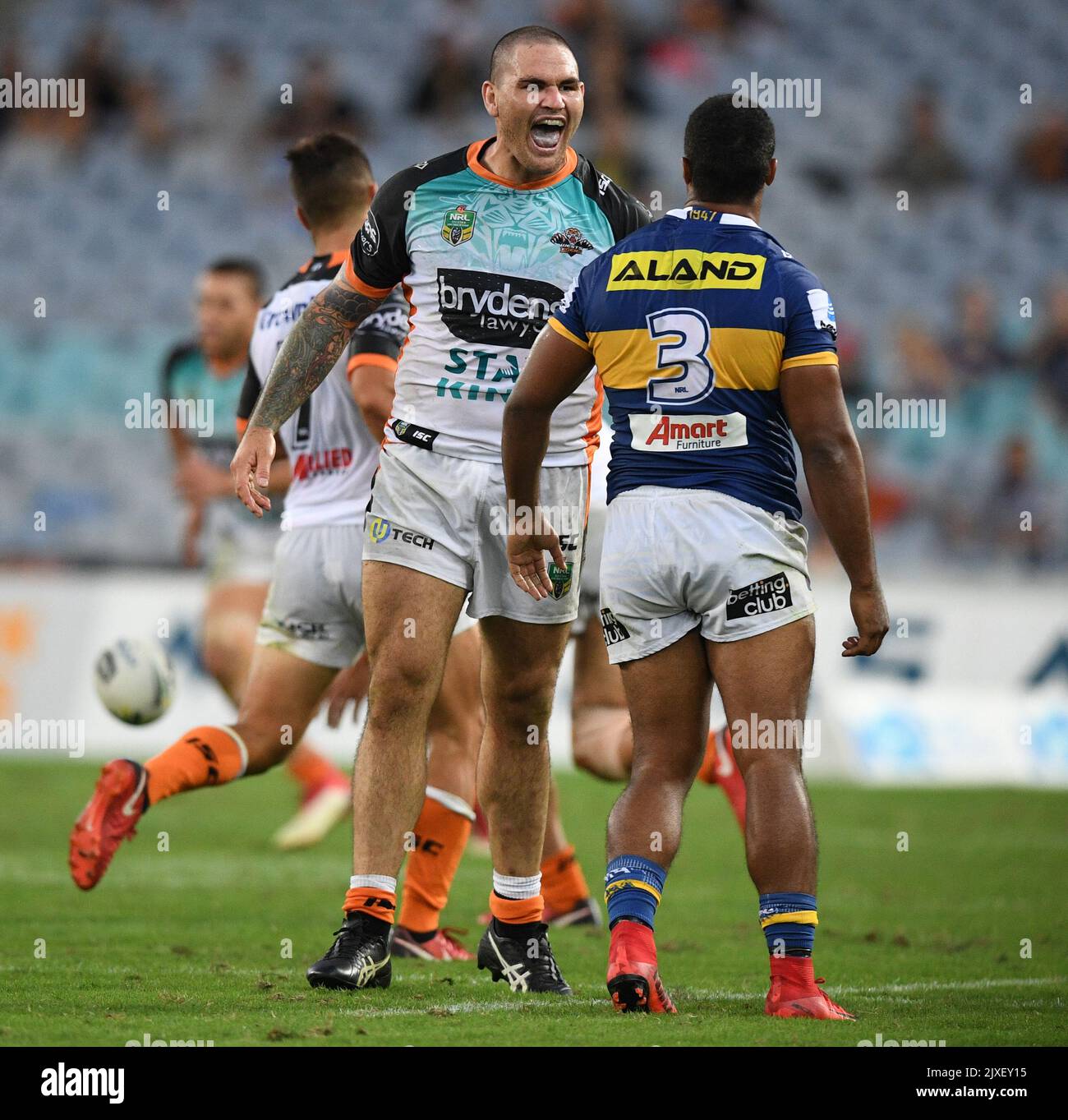 Russell Packer (centre) for the Tigers reacts with Michael Jennings of ...