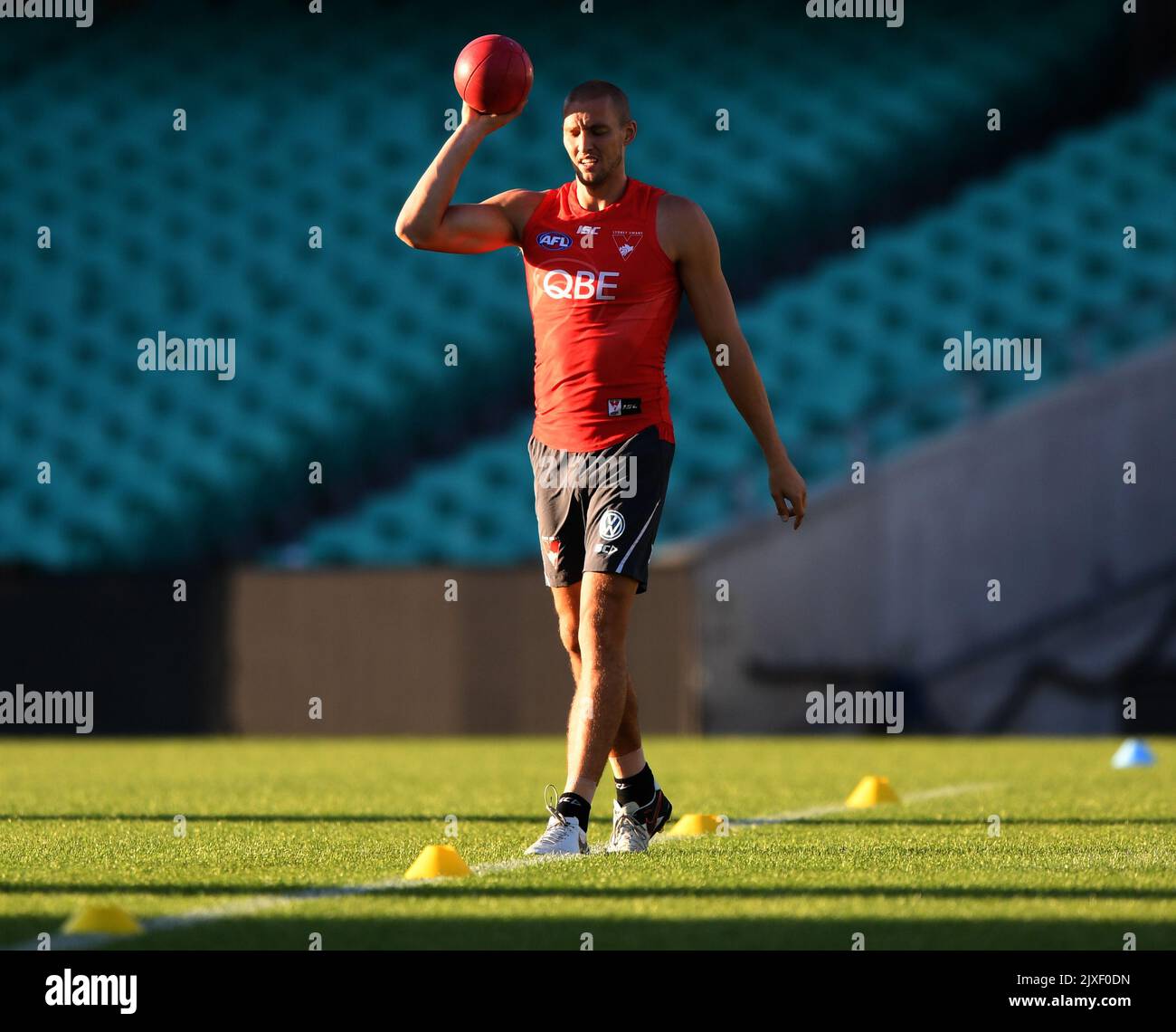 Sam Reid of the Sydney Swans walks with a ball during a team training ...