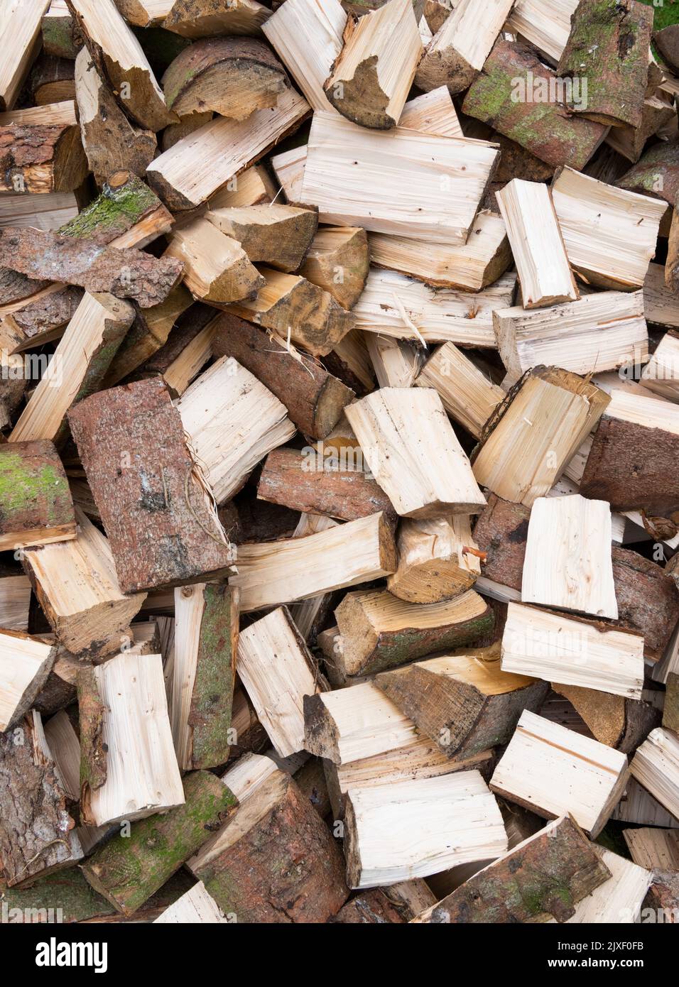 Pile of split logs Stock Photo - Alamy