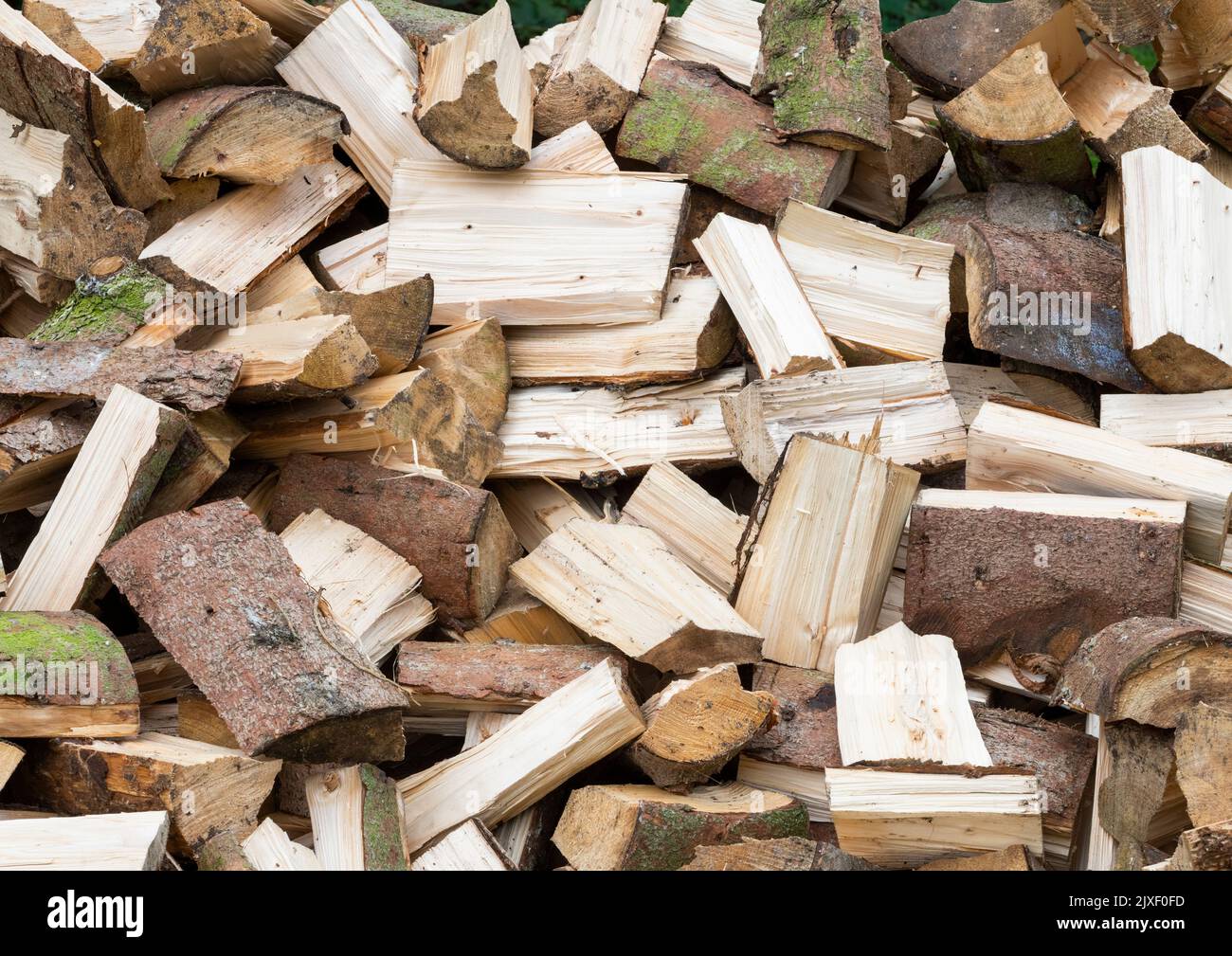 Pile of split logs Stock Photo - Alamy