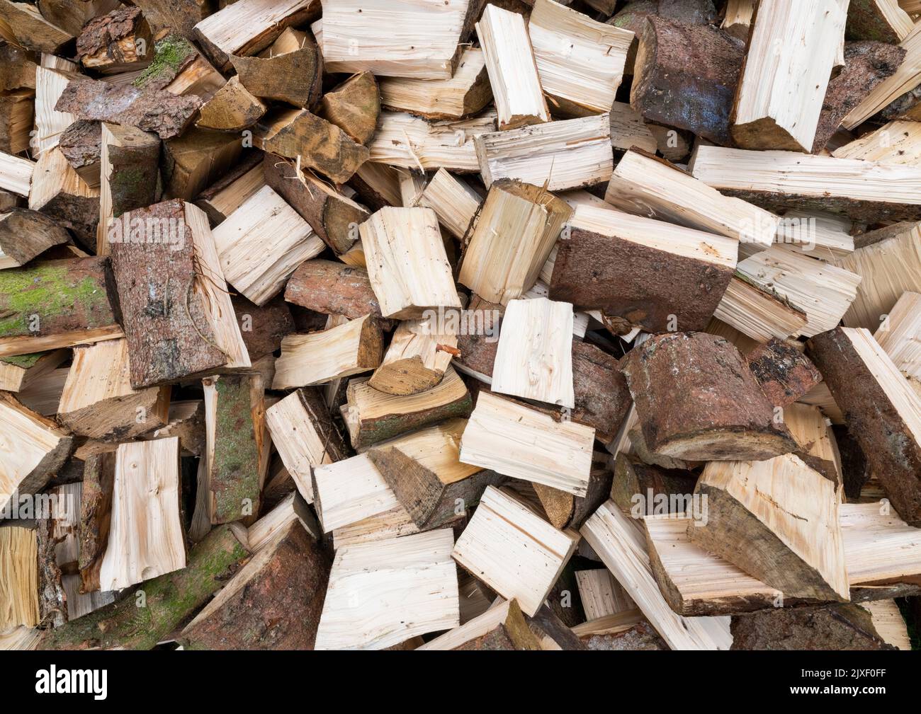 Pile of split logs Stock Photo - Alamy