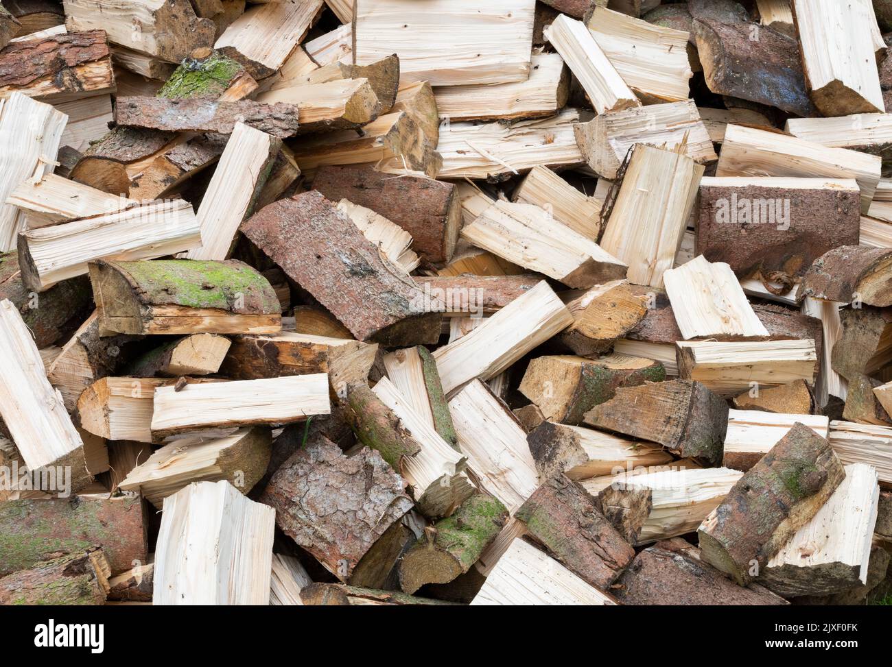 Pile of split logs Stock Photo - Alamy